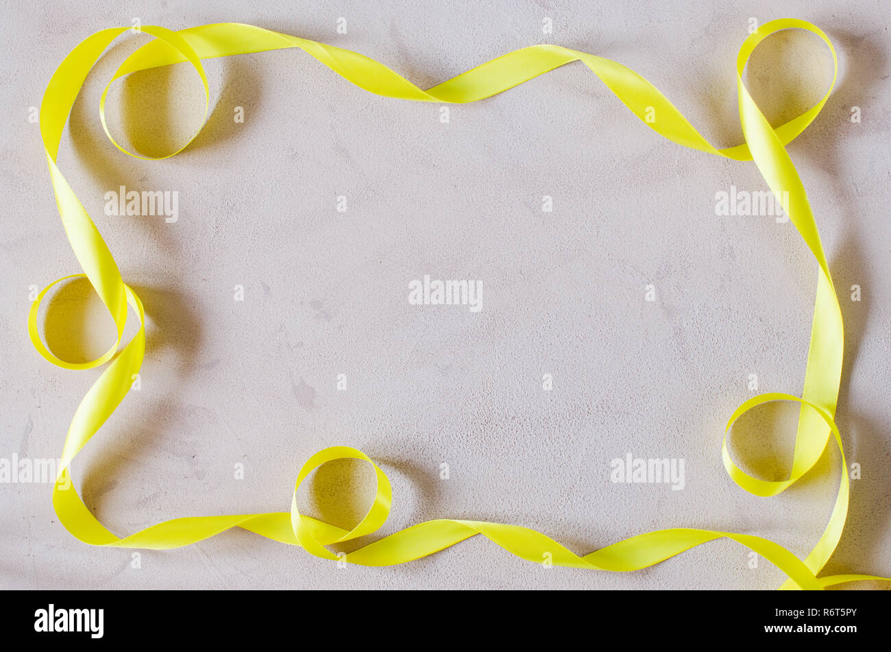 Decorative frame of satin yellow ribbon Stock Photo - Alamy