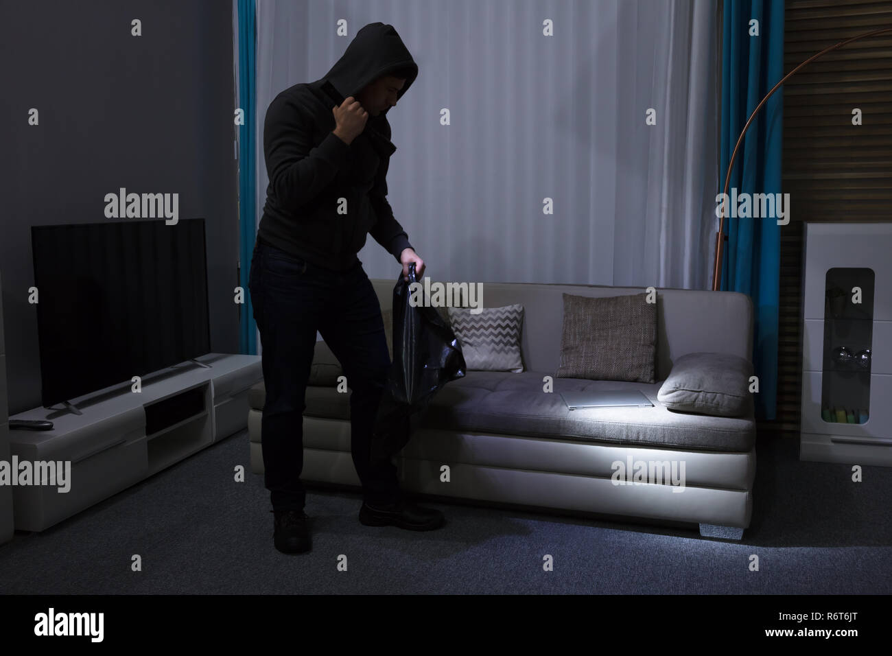 Robber Standing In Living Room Stock Photo - Alamy