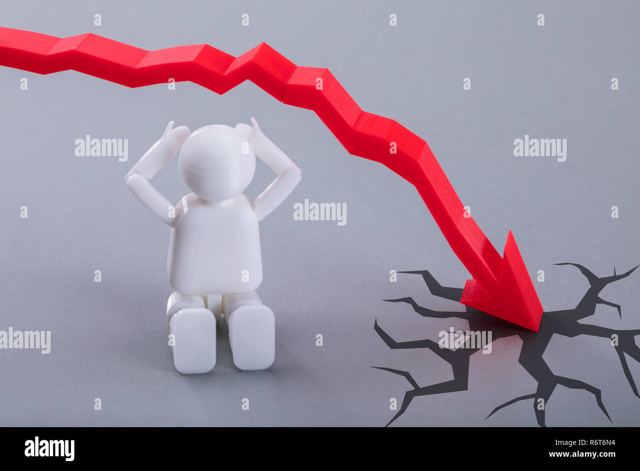 Close-up Of Human Figure Sitting Near Red Arrow Symbol Stock Photo - Alamy