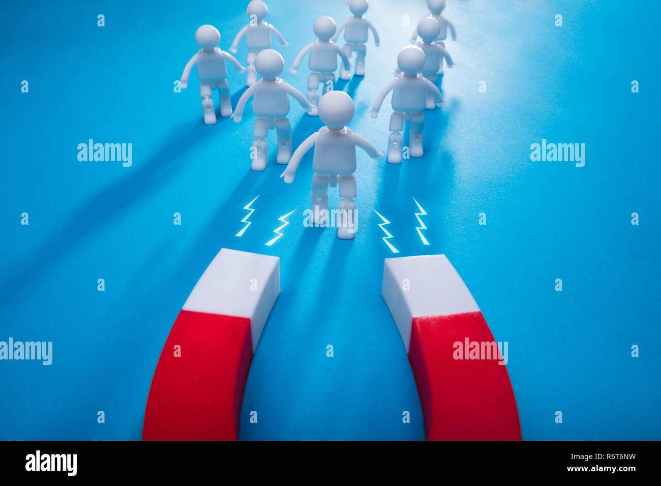 Elevated View Of Horseshoe Magnet Attracting Human Figures Stock Photo ...