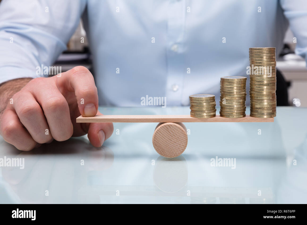 Businessperson Balancing Increasing Stacked Coins With Finger Stock ...