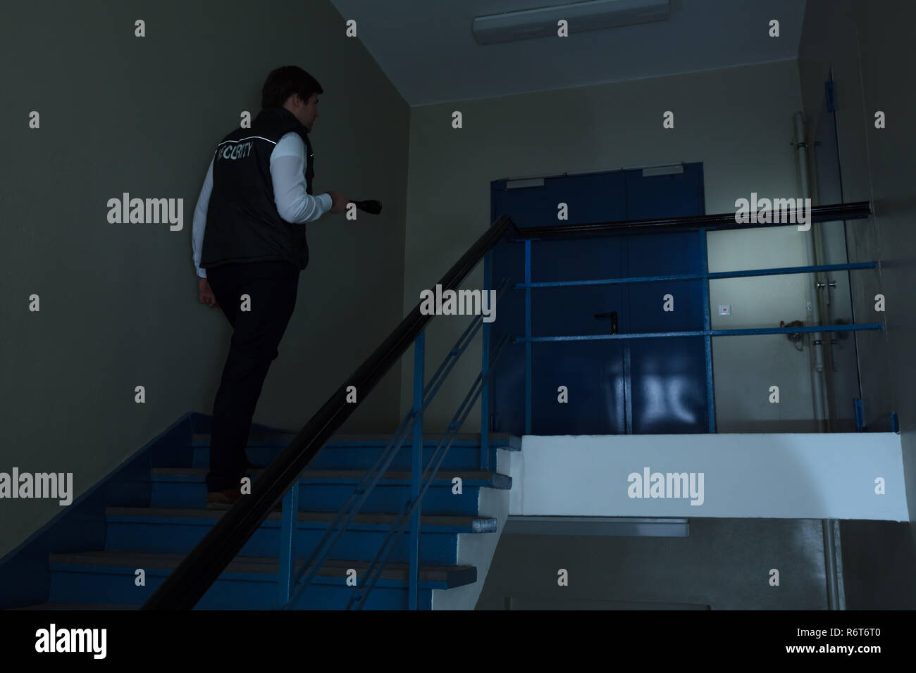 Security Guard Walking On Stairway Stock Photo - Alamy