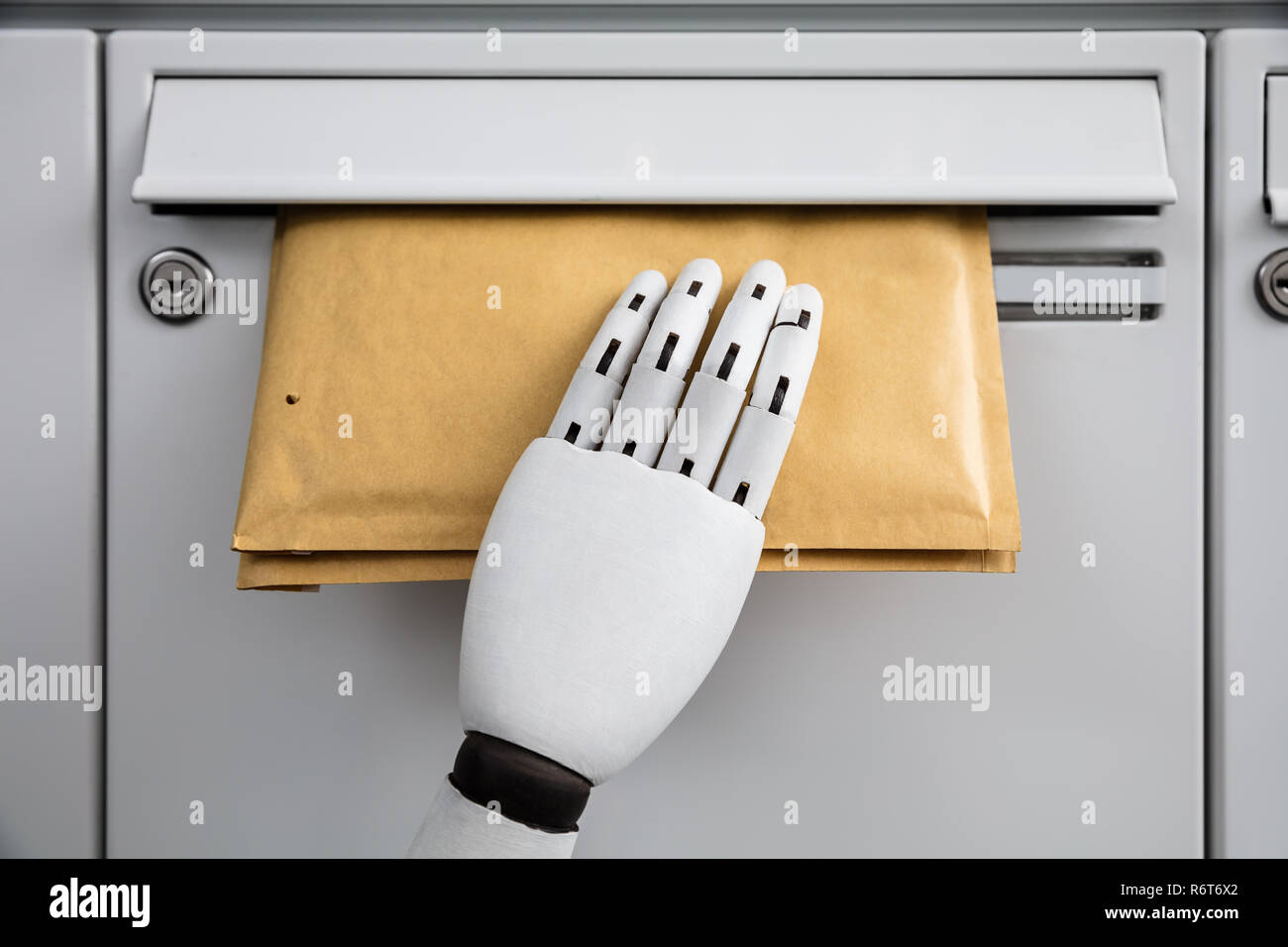 Robot Inserting Envelope In Mailbox Stock Photo - Alamy