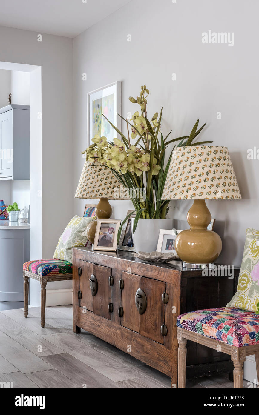 Upcycled chairs and wooden storage cabinet Stock Photo - Alamy