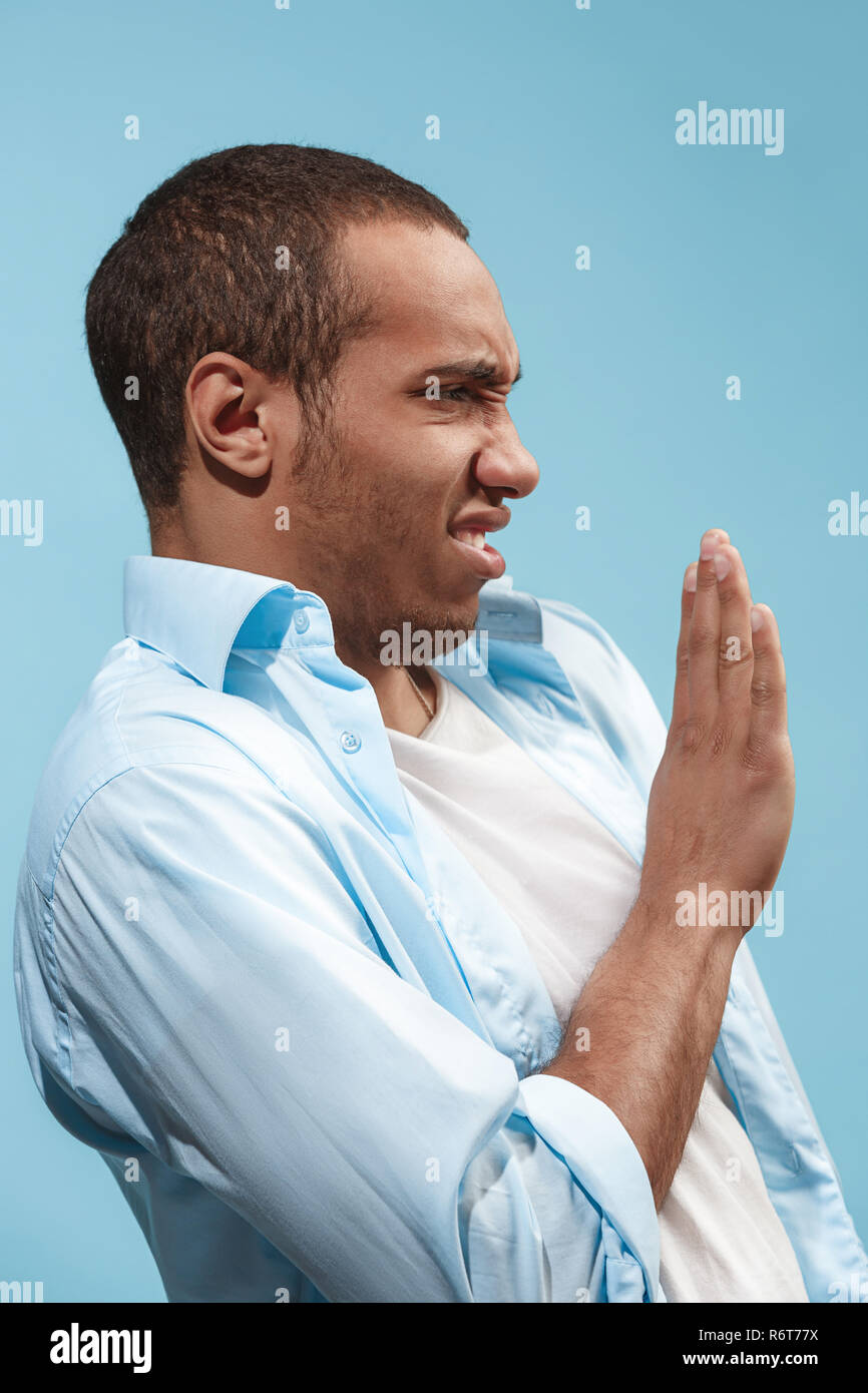 Young man with disgusted expression repulsing something, isolated on ...