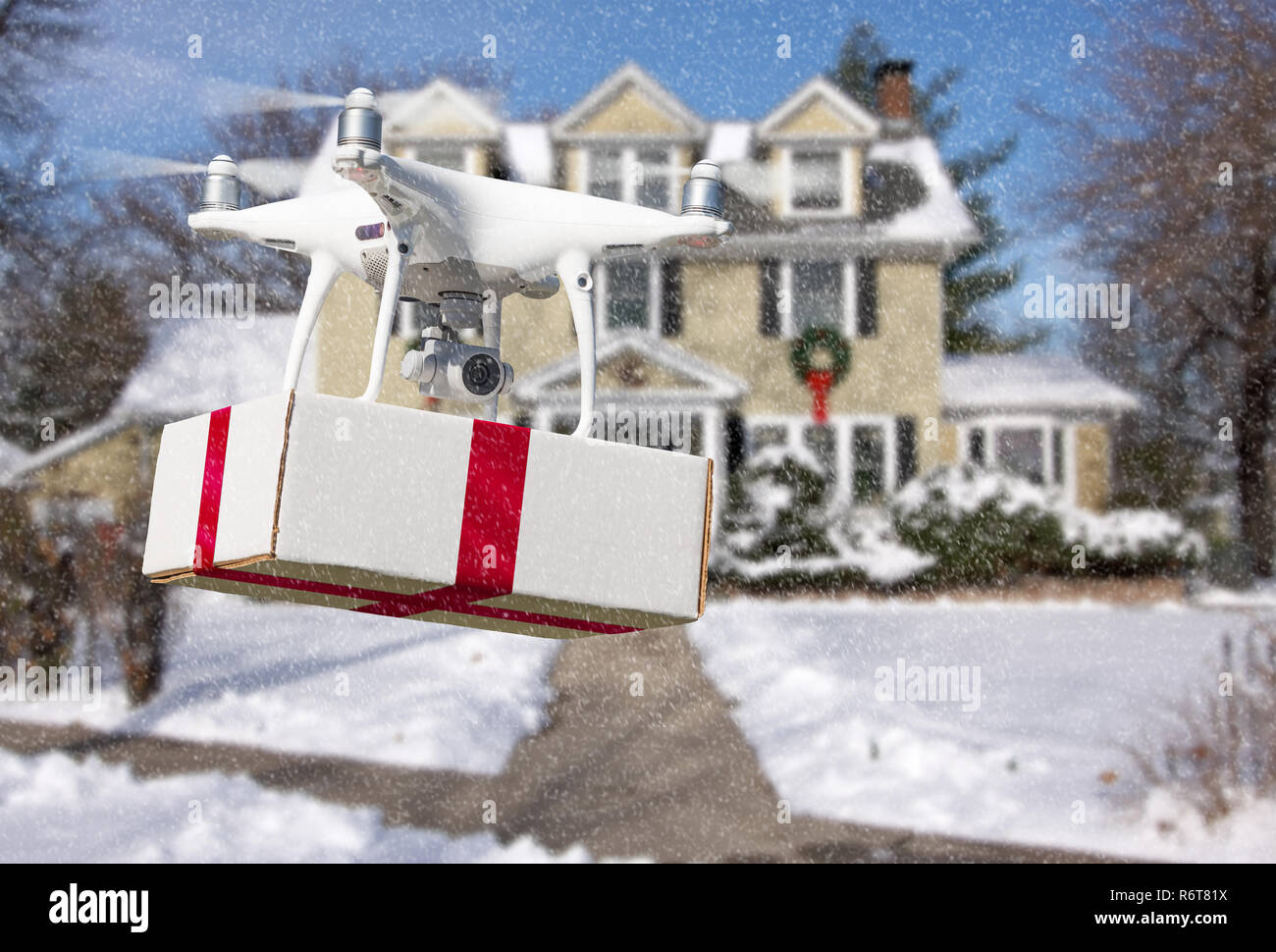 Unmanned Aircraft System (UAV) Quadcopter Drone Delivering Box With Red ...