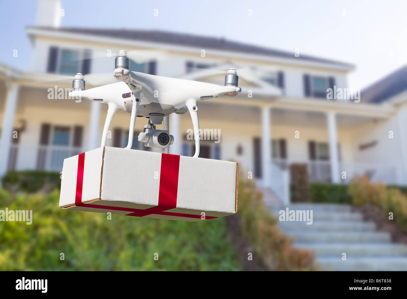 Unmanned Aircraft System (UAV) Quadcopter Drone Delivering Box With Red ...