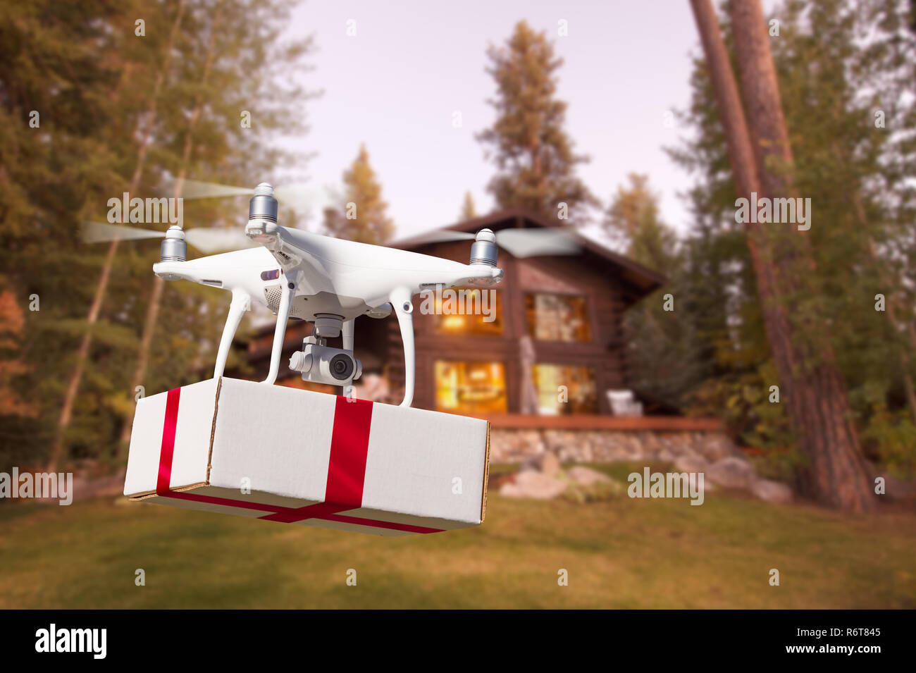 Unmanned Aircraft System (UAV) Quadcopter Drone Delivering Box With Red ...