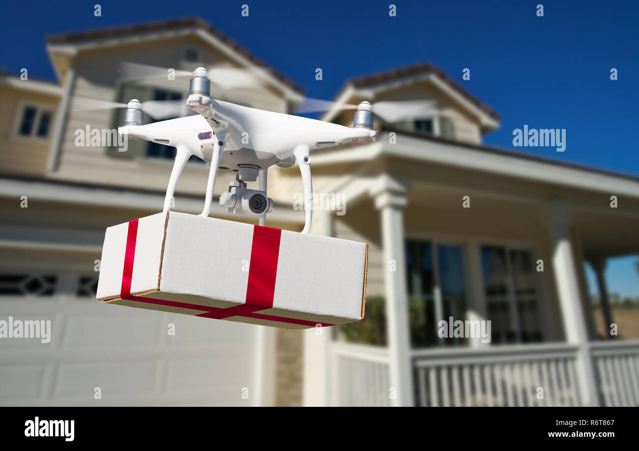 Unmanned Aircraft System (UAV) Quadcopter Drone Delivering Box With Red ...