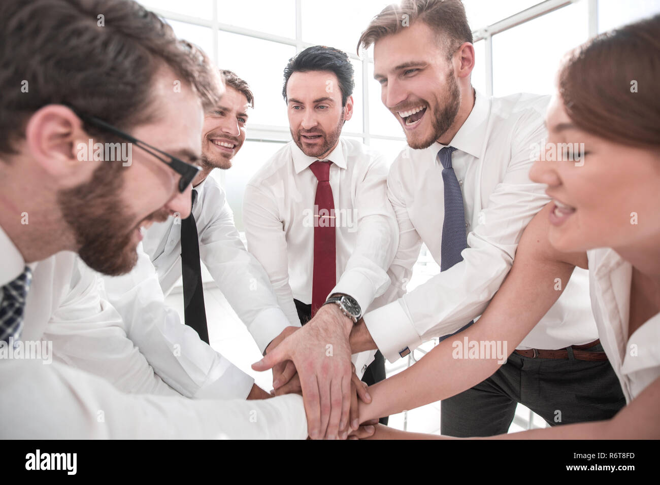 happy business team connects their hands together Stock Photo - Alamy