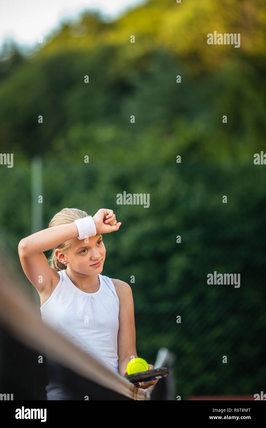Young, teen tennis player on court Stock Photo - Alamy