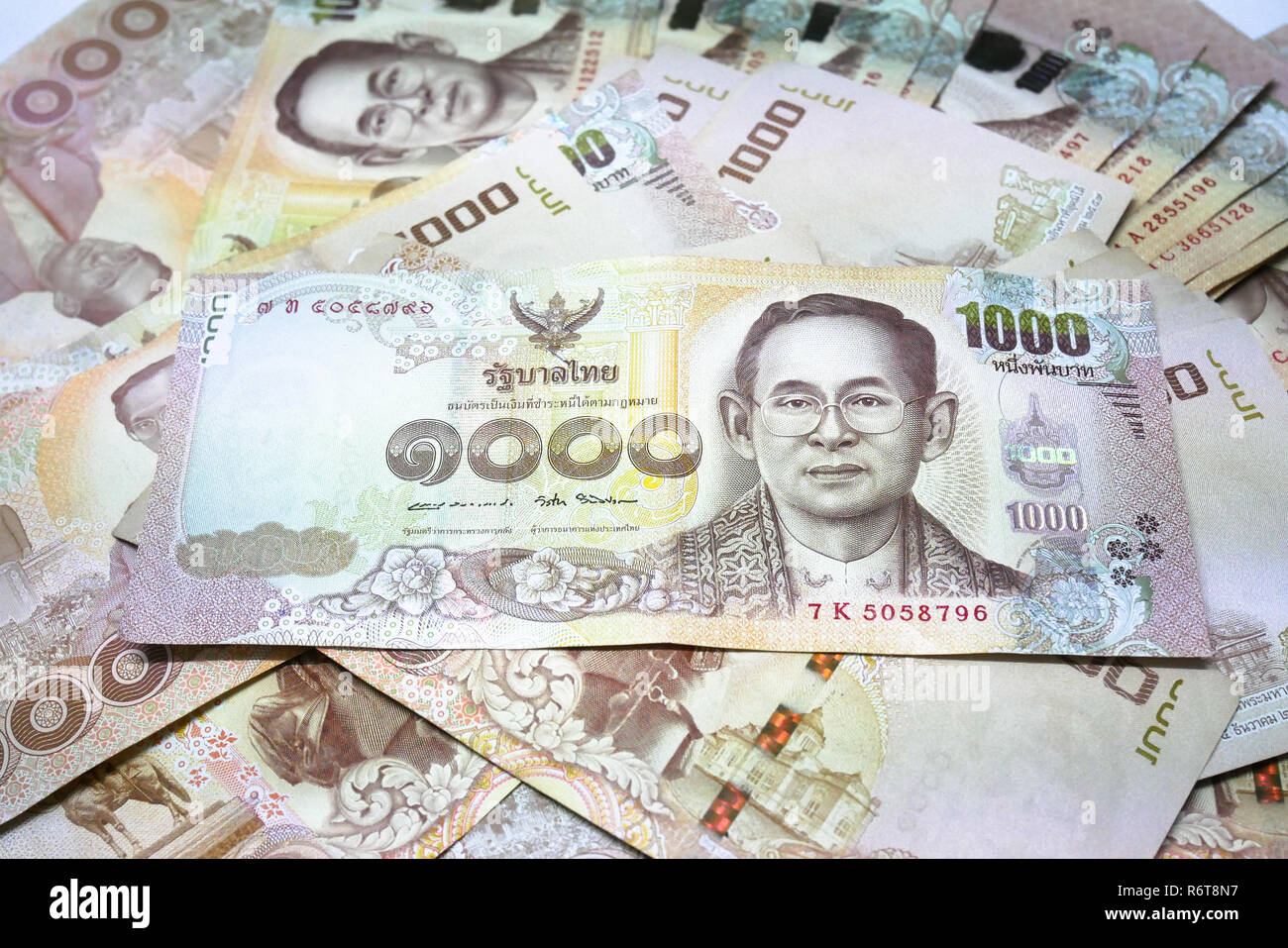 One thousand baht banknotes put on the isolated white background that ...