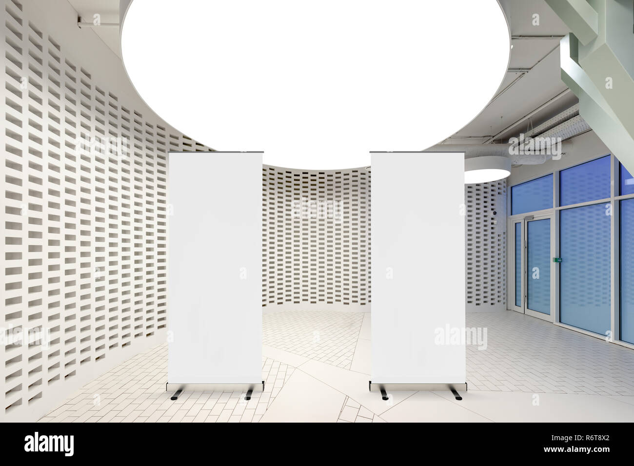 Two blank roll up banner stand in contemporary office interior with ...