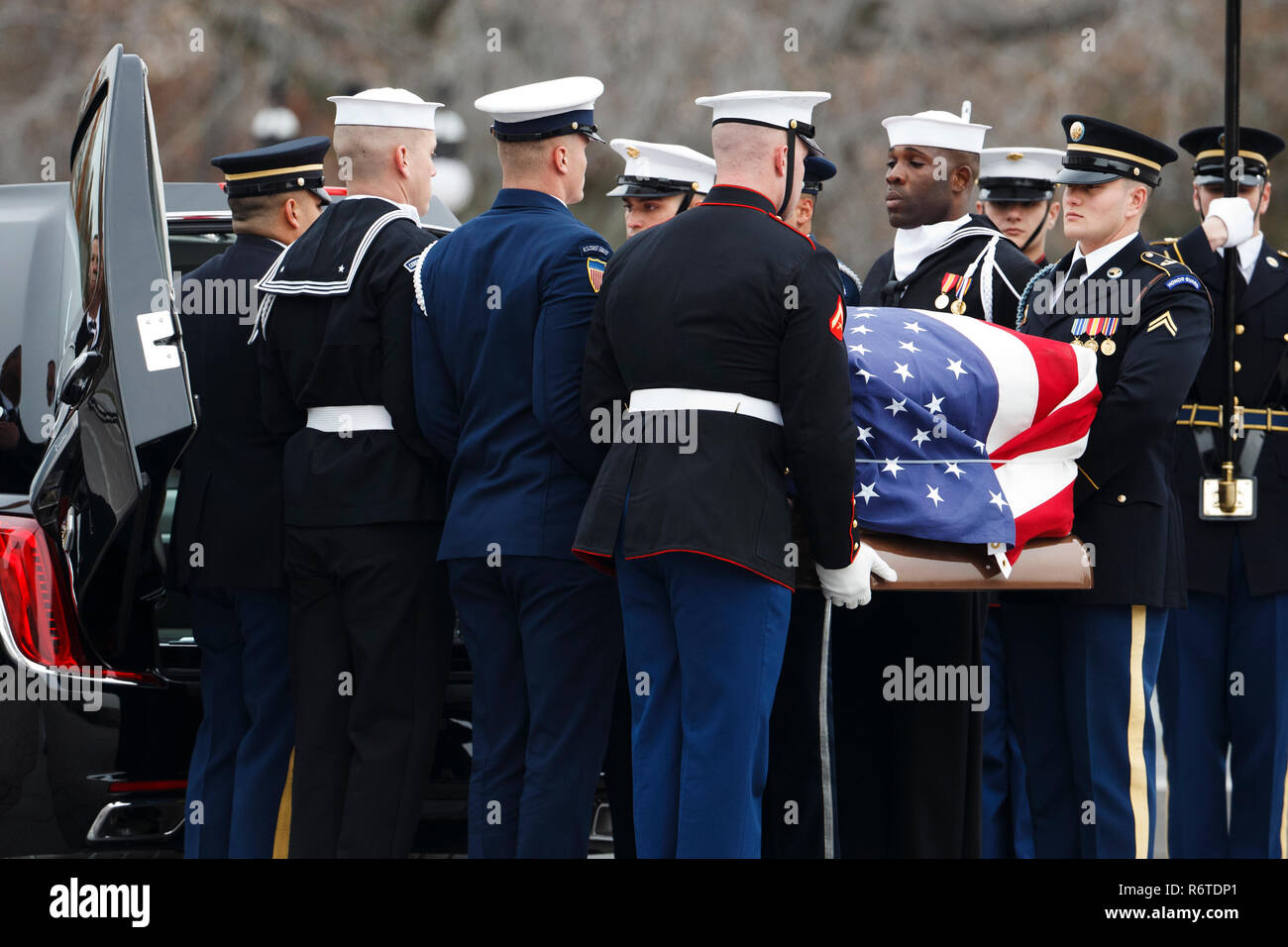 The flag-draped casket of former President George H.W. Bush is carried ...