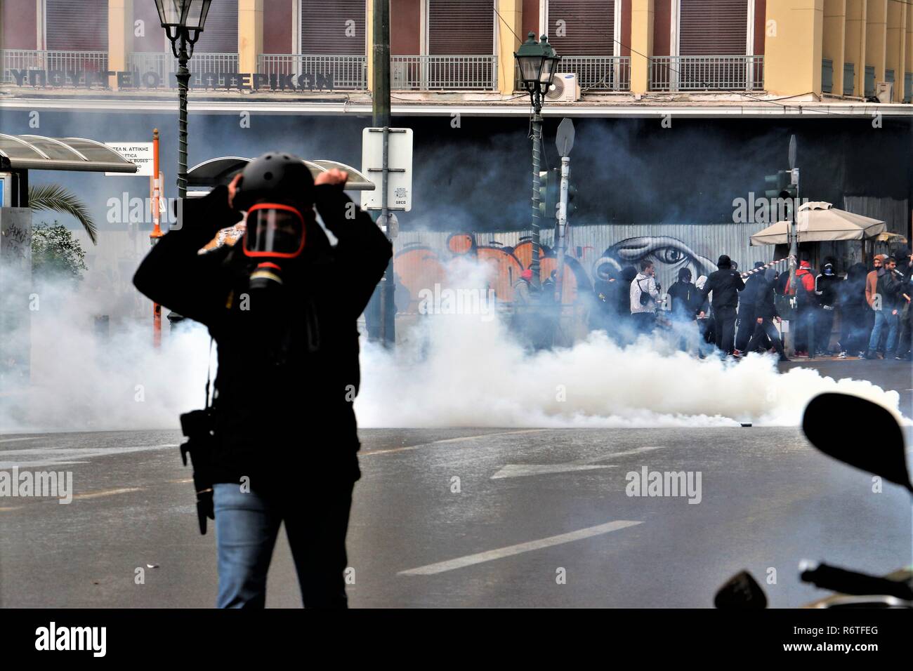 Athens, Greece. 6th Dec, 2018. A journalist seen putting on a tear gas ...