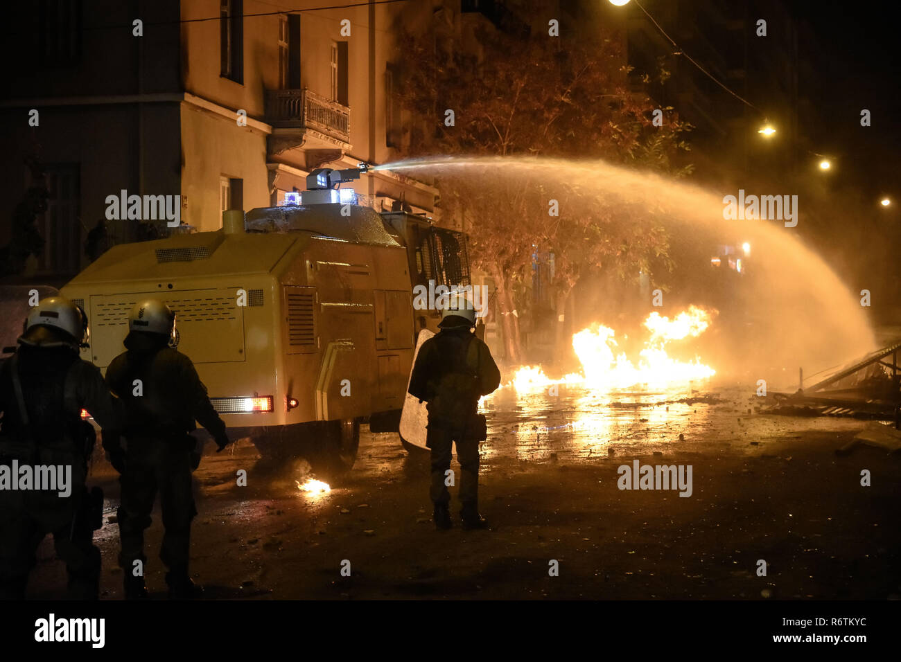 A Police water cannon truck seen extinguish the fire as riot policemen ...