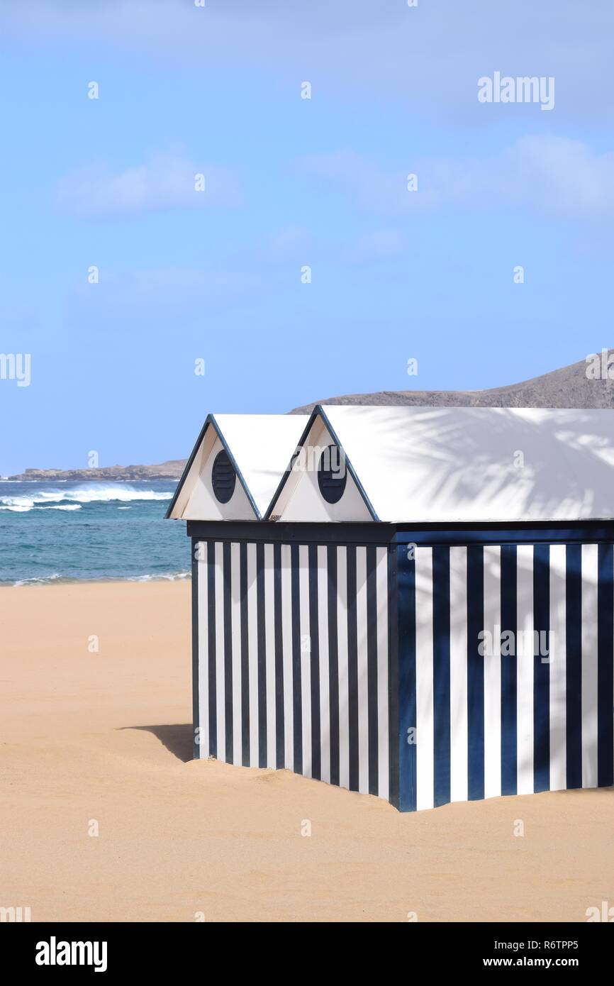 white blue striped painted wooden huts,beach huts on the sunny beach ...