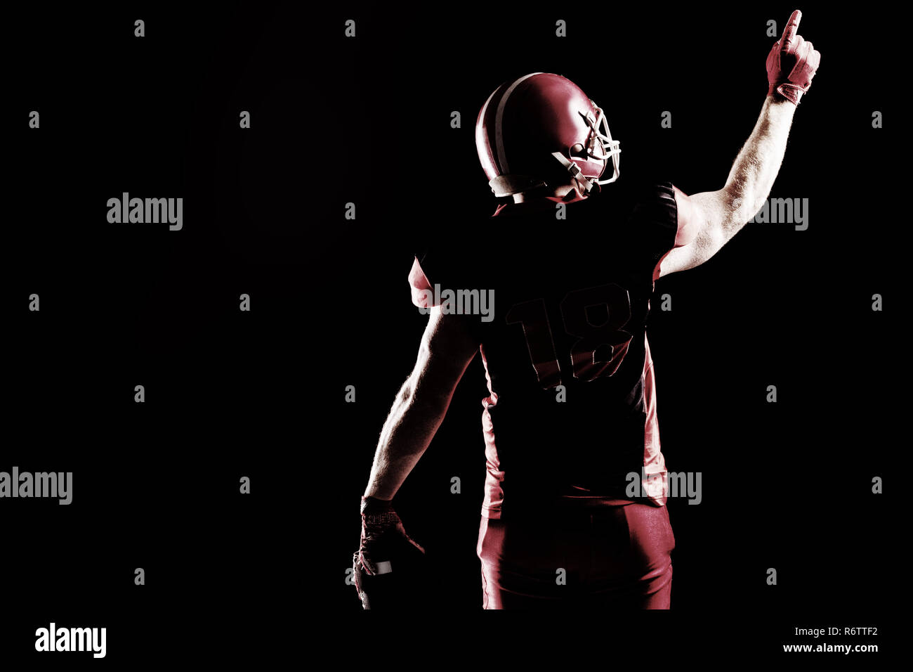 Rear view of American football player in helmet pointing upwards Stock ...