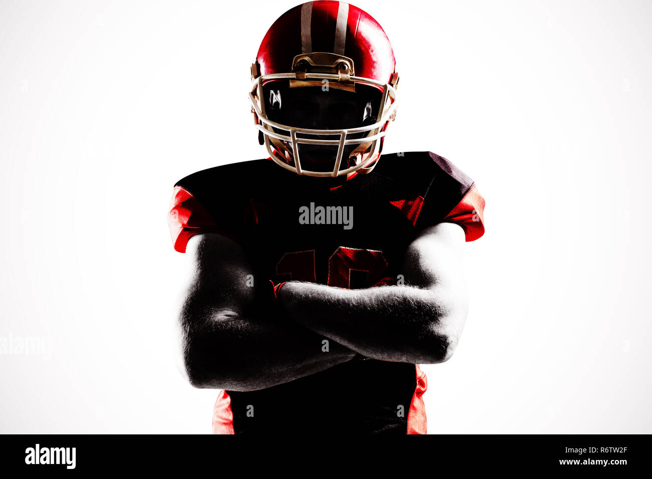 Young American football player standing with arms crossed Stock Photo ...