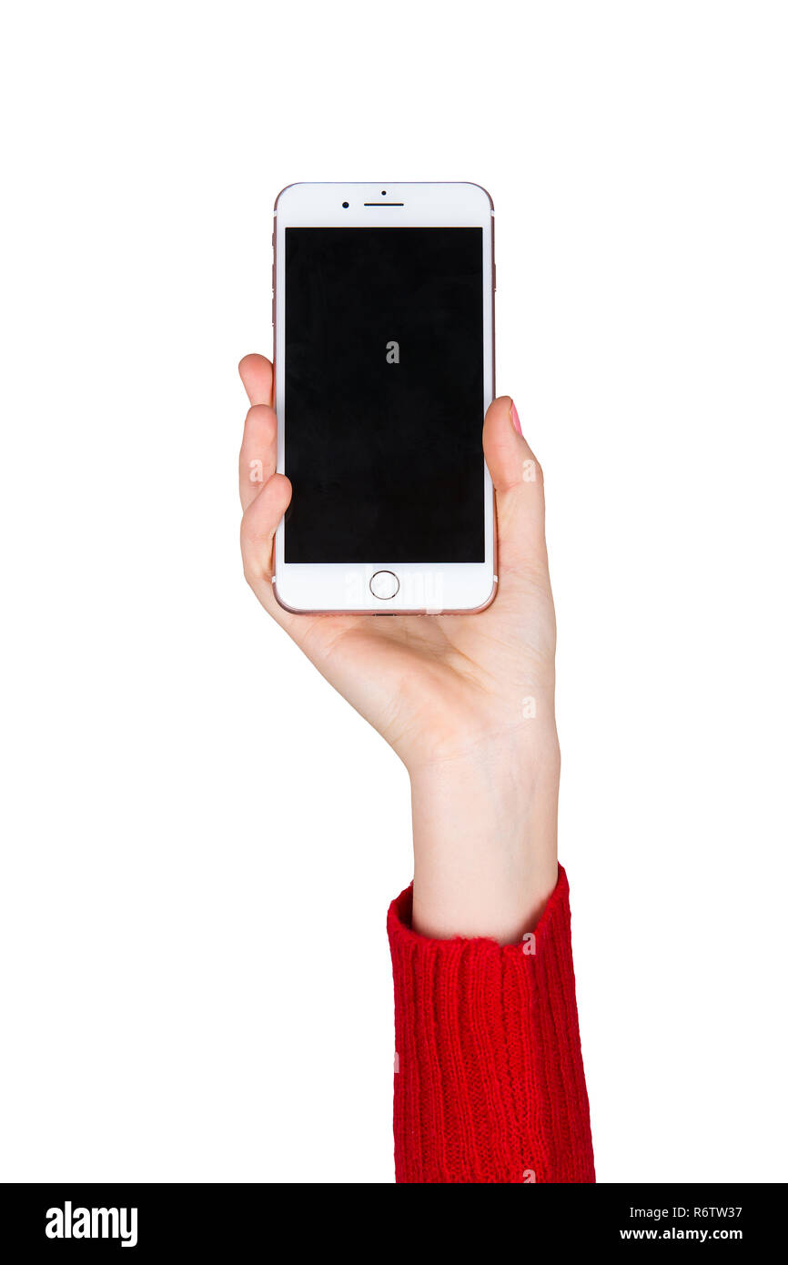 Woman hand raised up holding a smart cell phone showing touch mobile ...