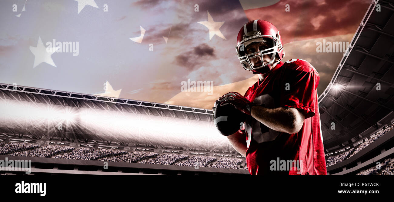 American football player standing with helmet preparing to throw ball ...