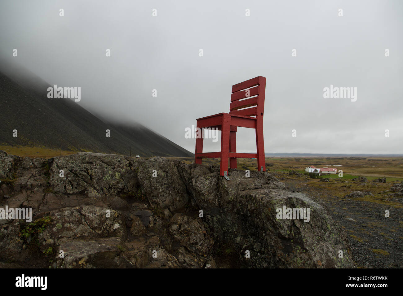 A wooden big red chair on a rock at seaside near Eystrahorn, East ...