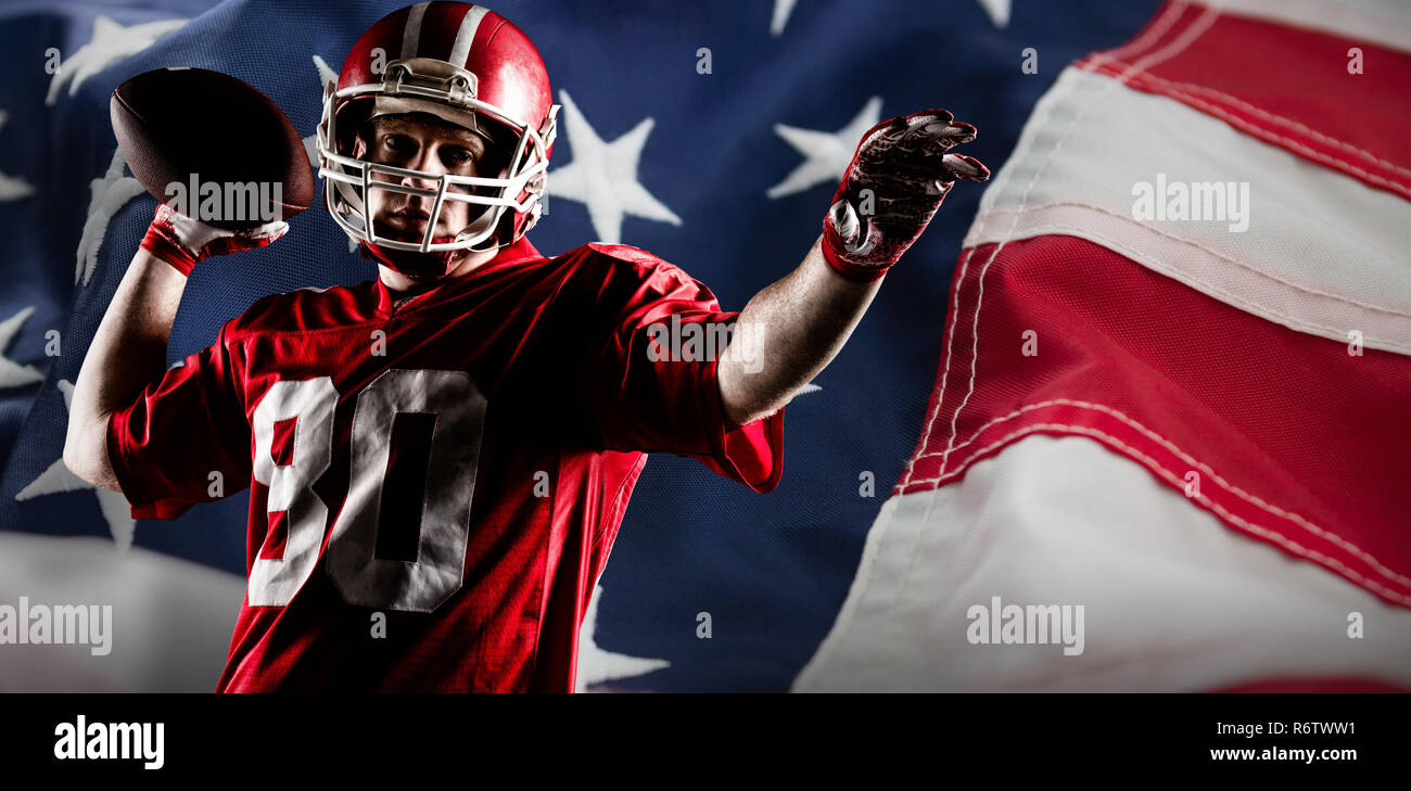 American football player throwing rugby ball against full frame of ...
