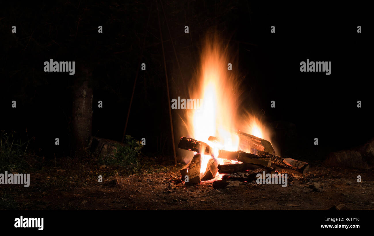 Campfire in the dark scene Stock Photo - Alamy