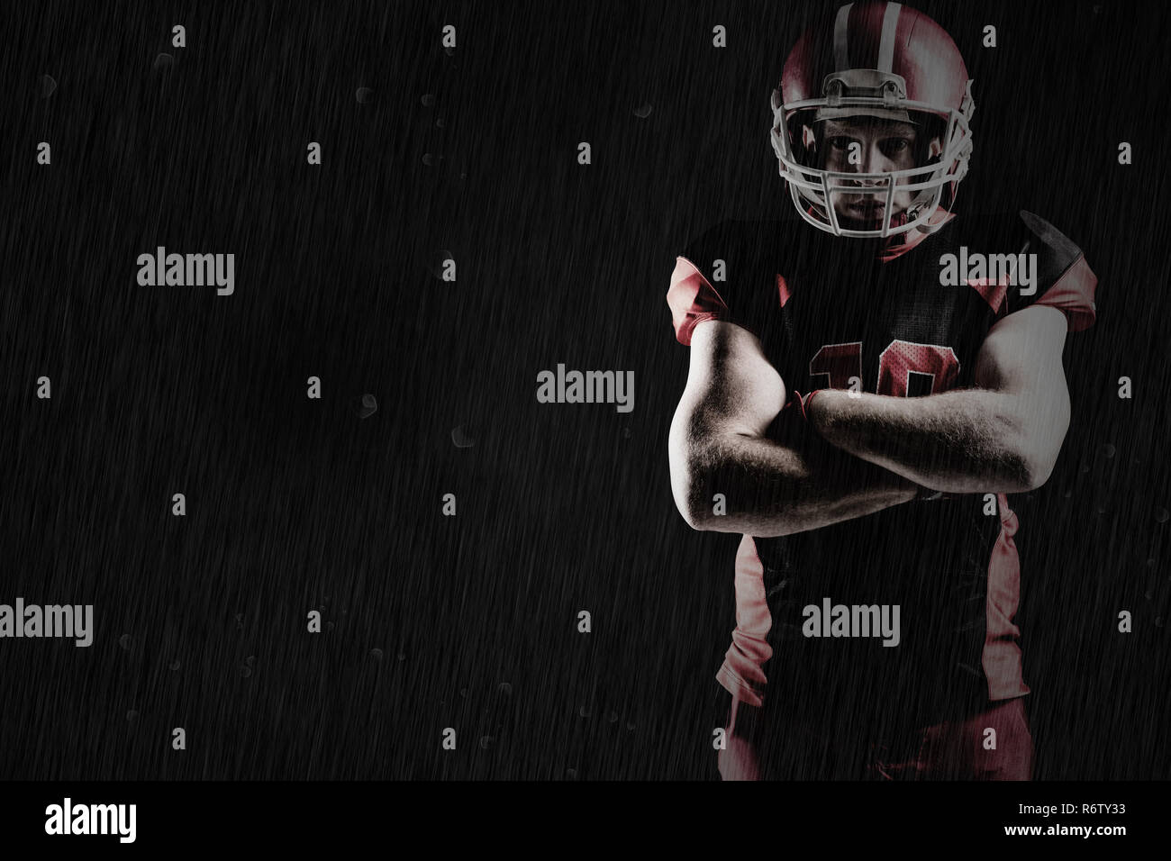 Composite image of american football player standing with arms crossed ...