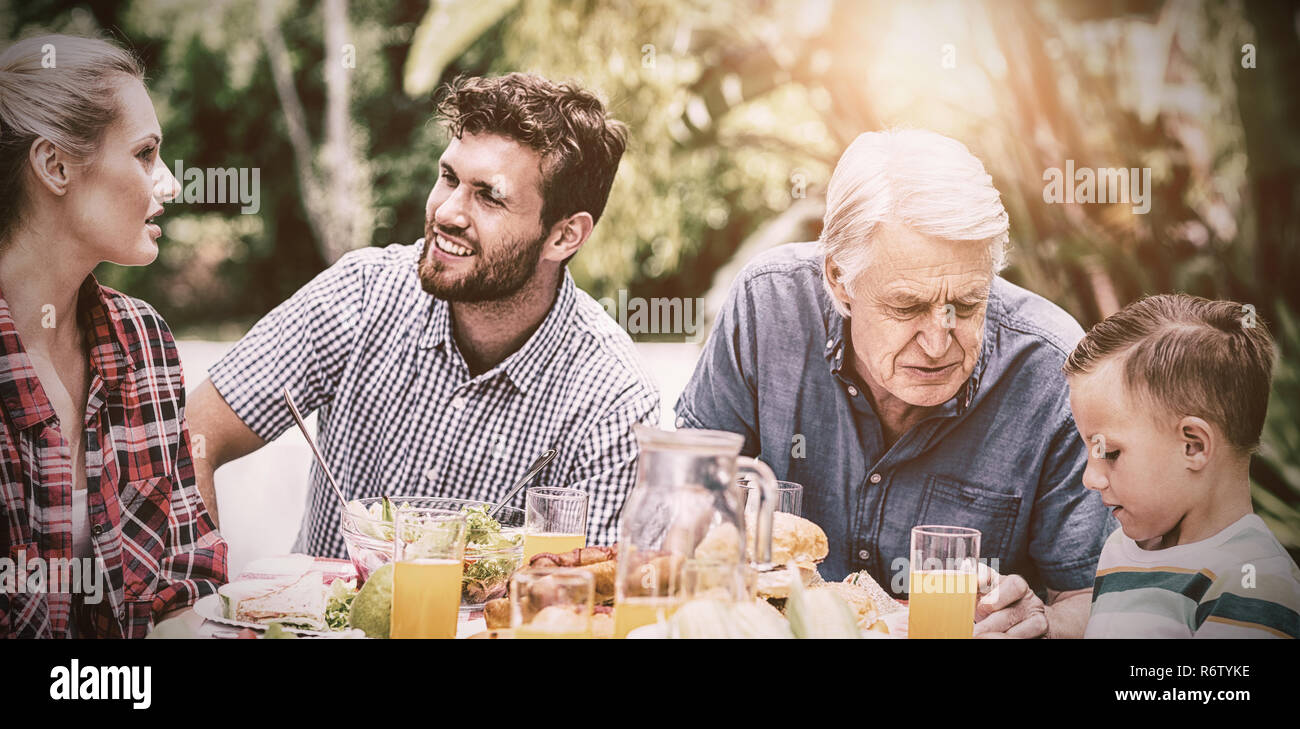 Family communicating at yard Stock Photo - Alamy