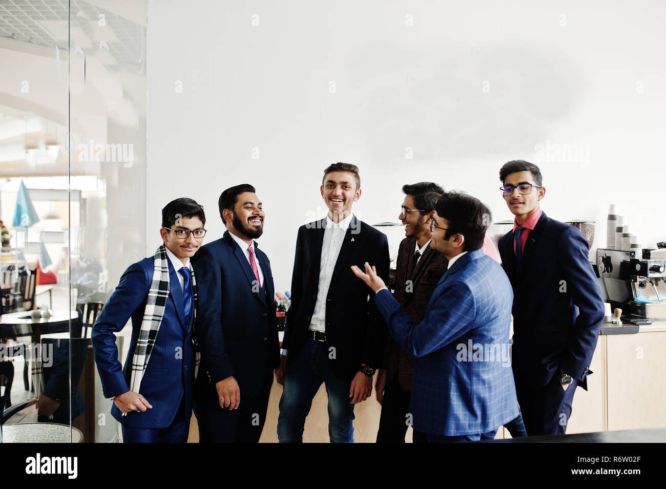 Group of six indian business man in suits standing on cafe and disscuss ...
