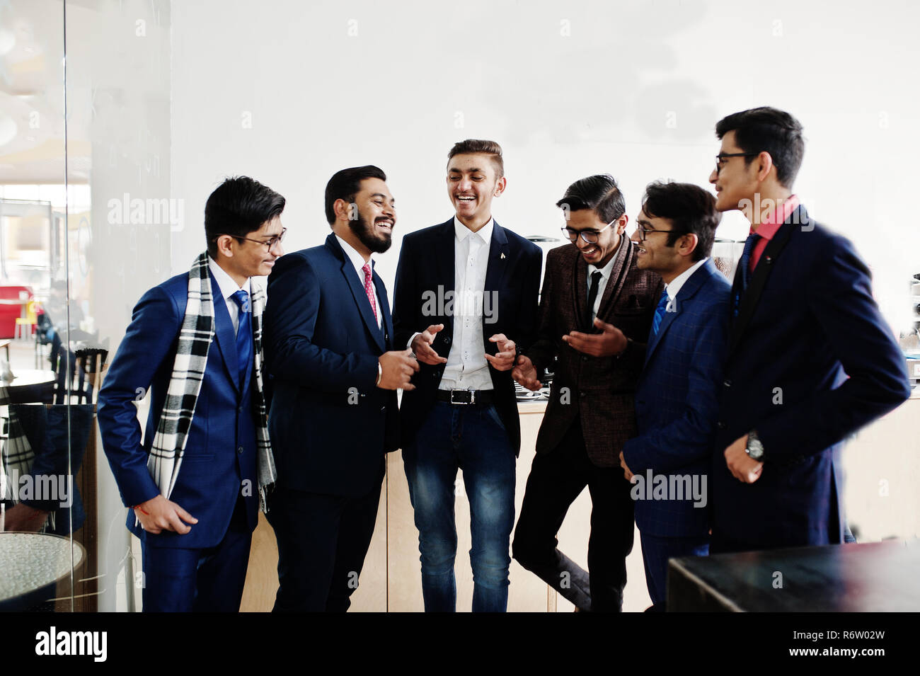 Group of six indian business man in suits standing on cafe and disscuss ...