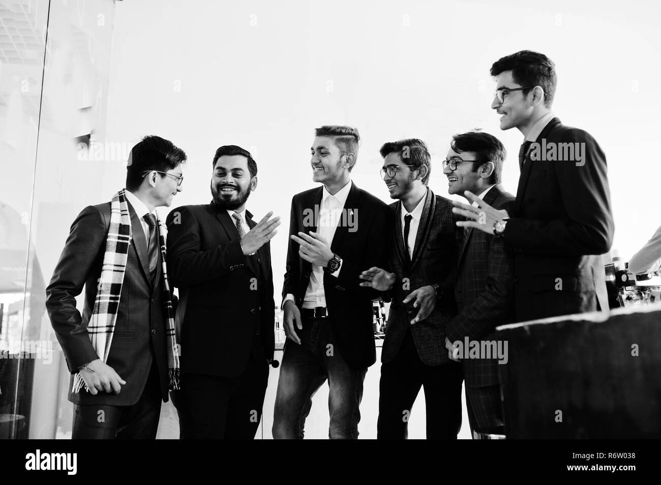 Group of six indian business man in suits standing on cafe and disscuss ...