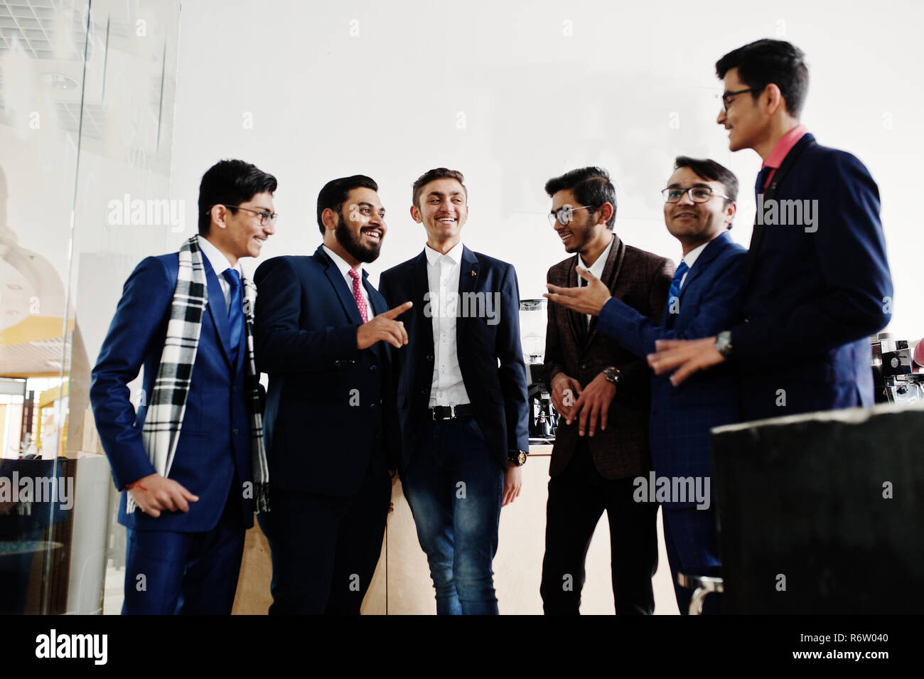 Group of six indian business man in suits standing on cafe and disscuss ...