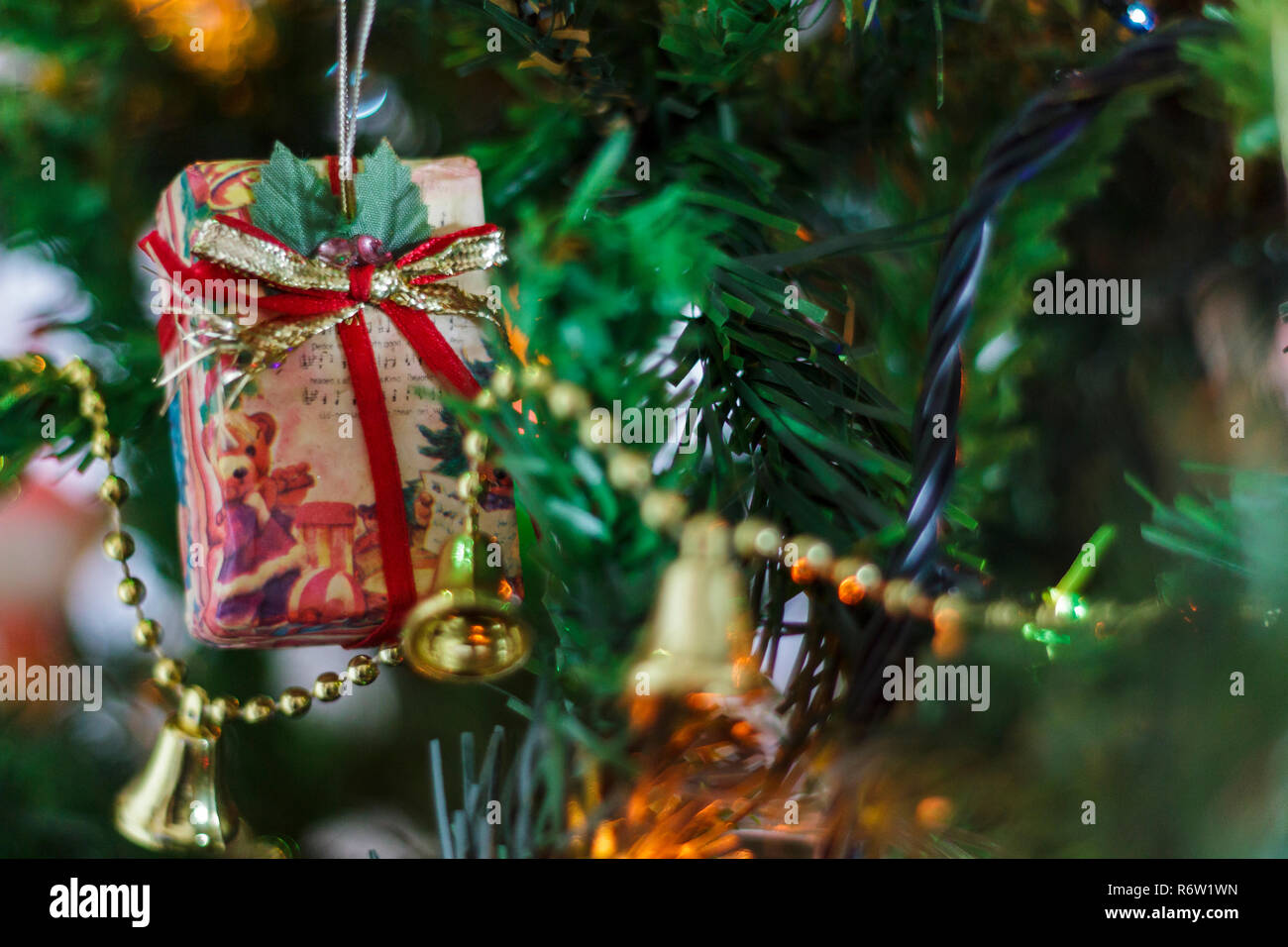 Gift hanging on Christmas tree Stock Photo - Alamy