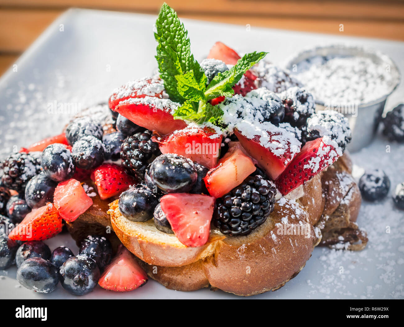 Challah French toast stuffed with honeyed ricotta, topped with fruit ...