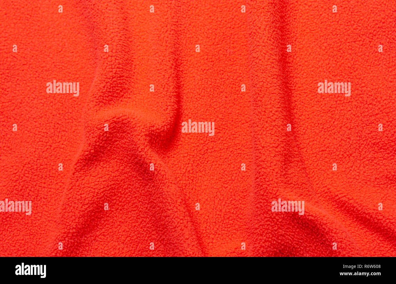 Red soft fleece texture. The surface of a teddy crumpled microfiber rug ...