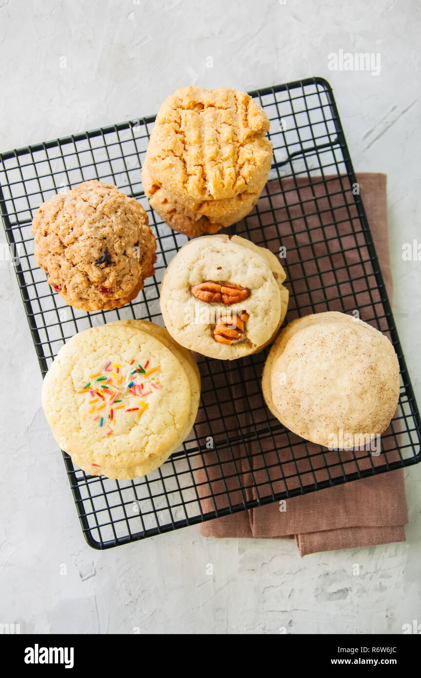 Set of festive cookies on a wire rack. Peanut butter, pecan, oatmeal ...
