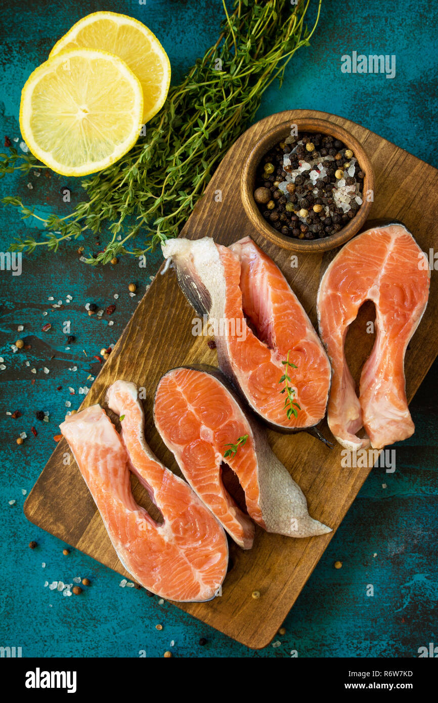 Fresh Fish. Raw Salmon Steak on a blue slate table. Top view flat lay ...