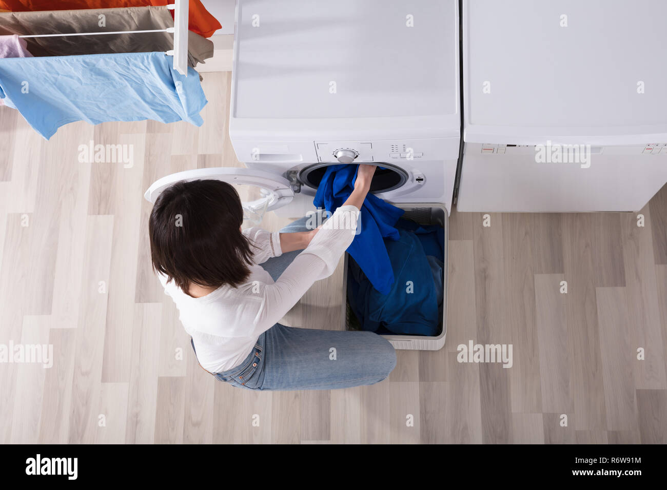 Woman Putting Dirty Cloth Into Washing Machine Stock Photo - Alamy