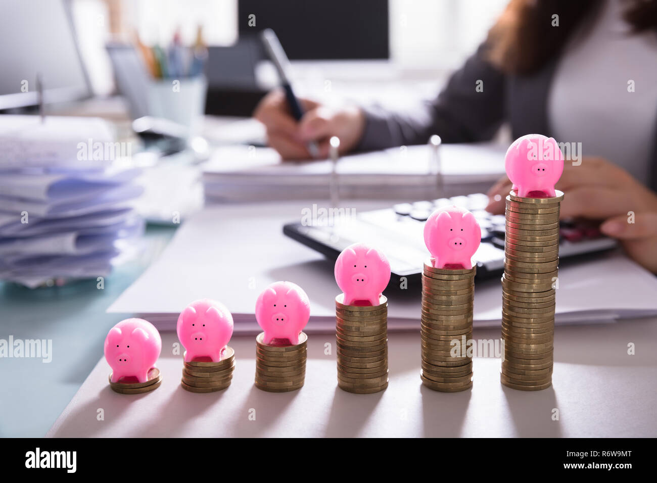 Woman stacked coins calculator hi-res stock photography and images - Alamy