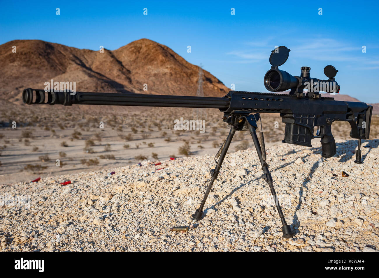 sniper rifle resting in a rugged desert landscape Stock Photo - Alamy