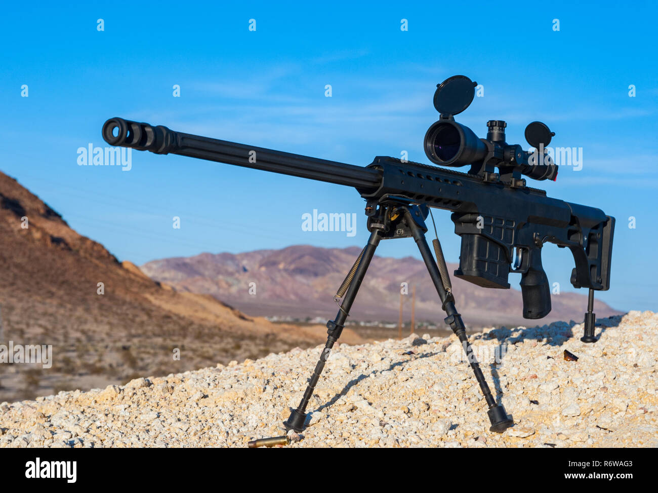 sniper rifle resting in a rugged desert landscape Stock Photo - Alamy