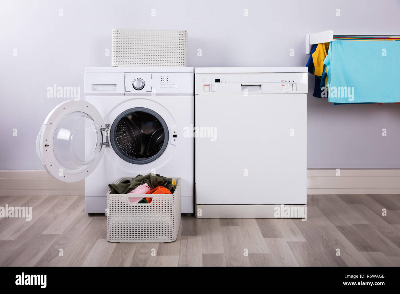 Empty Washing Machine With Pile Of Dirty Clothes Stock Photo - Alamy