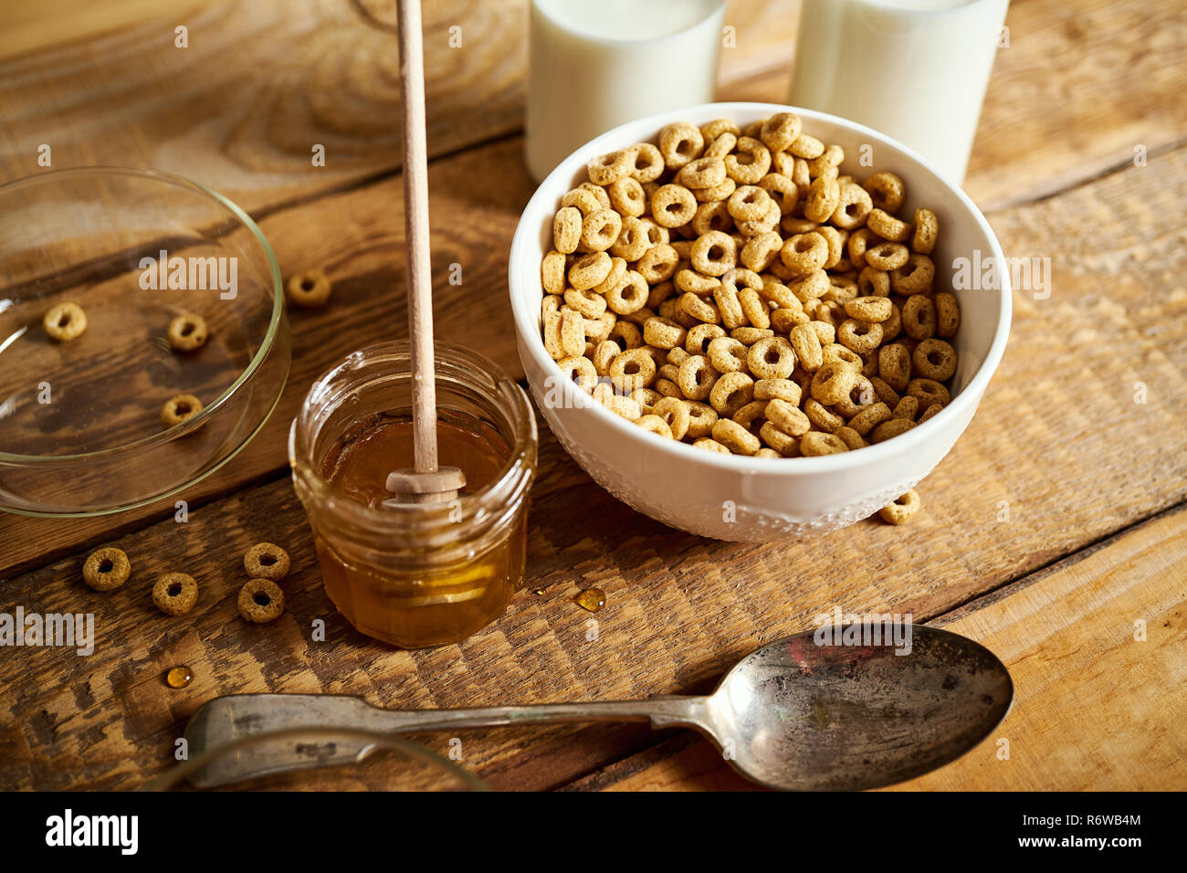 Healthy morning breakfast bowl full of honey flakes with honey dipper ...