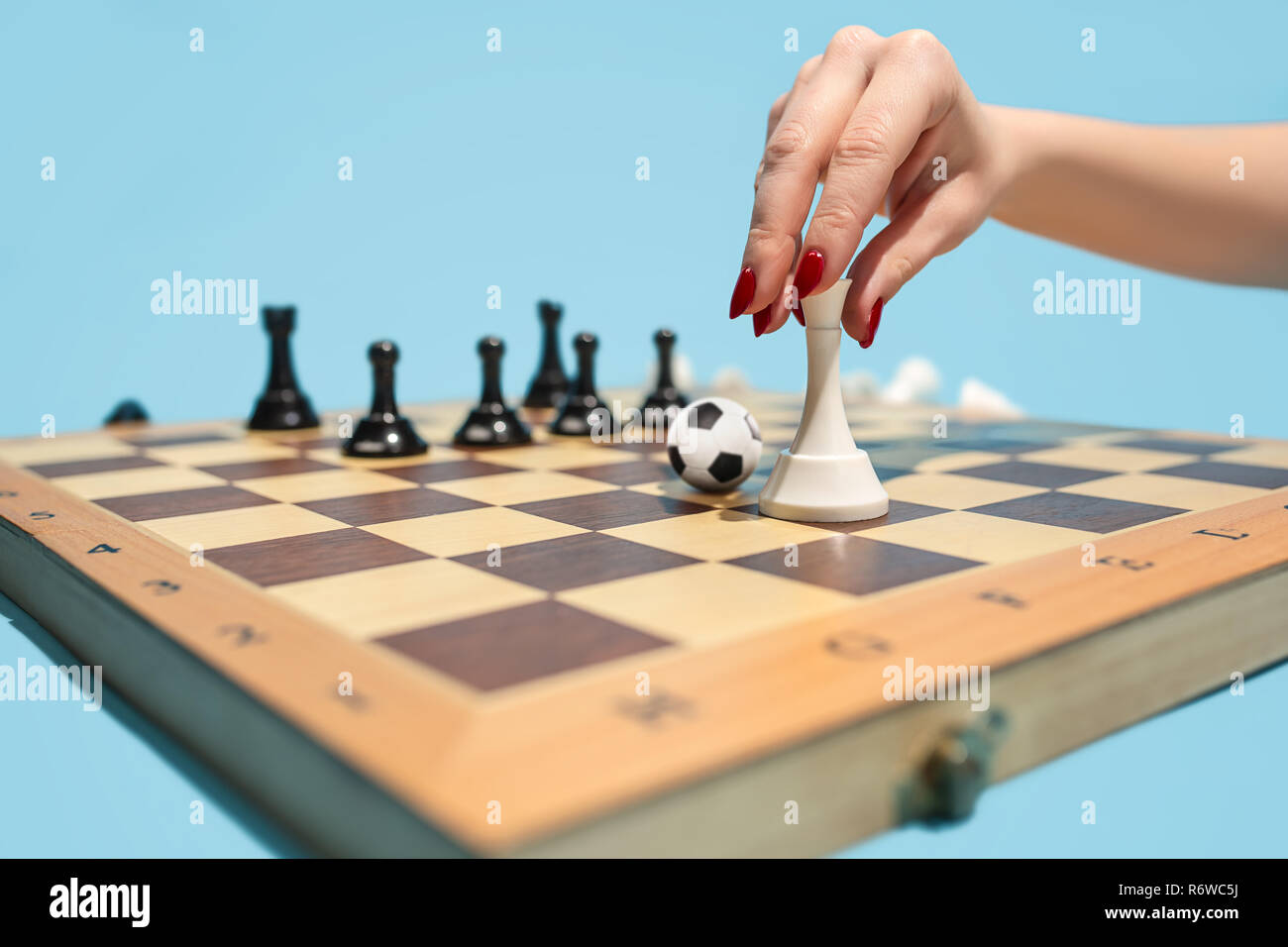 soccer ball of chess pieces on the board Stock Photo - Alamy