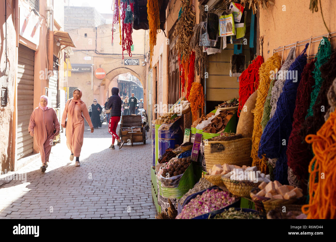 Marrakech Medina - street scene with goods for sale and local people ...