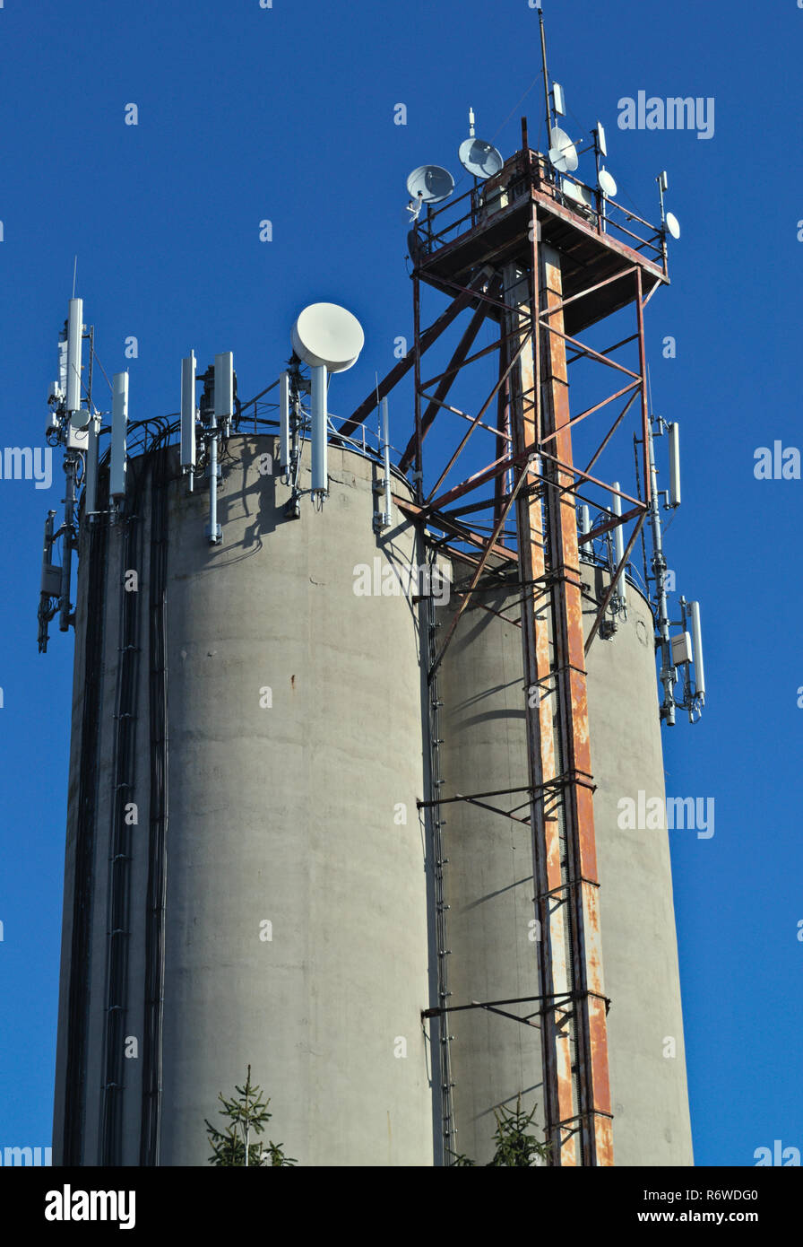 Concrete grain elevator with bunch of antennas on top of it Stock Photo ...