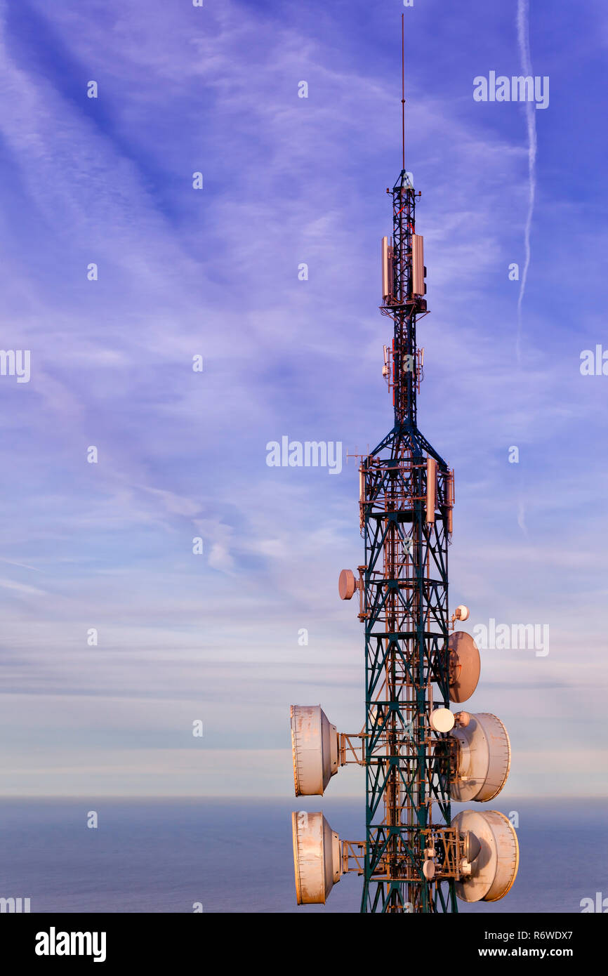 Detail of a telecommunications tower with the sea in the background ...