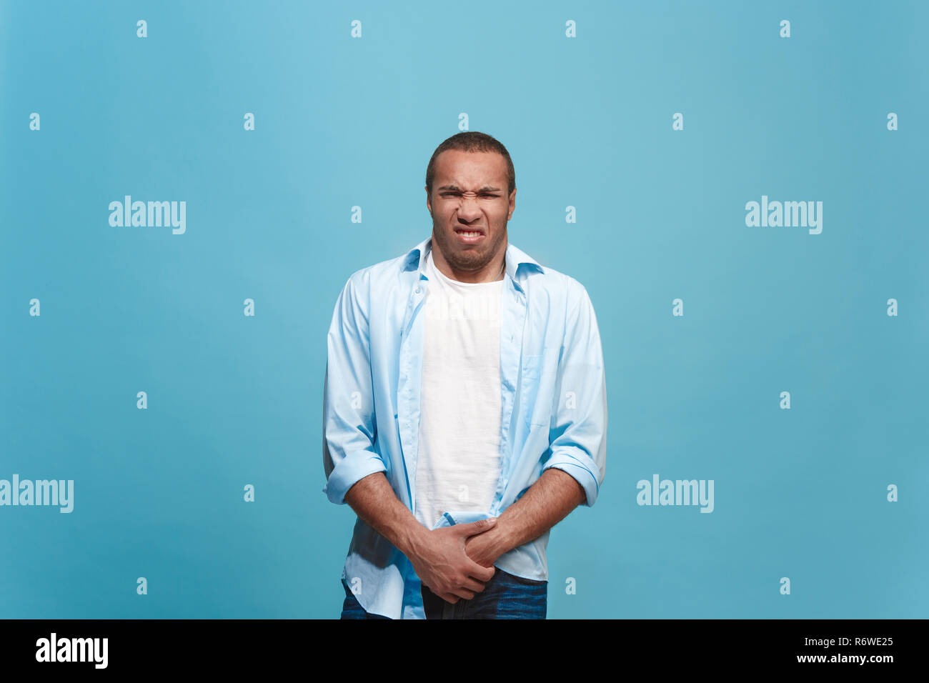 Young man with disgusted expression repulsing something, isolated on ...